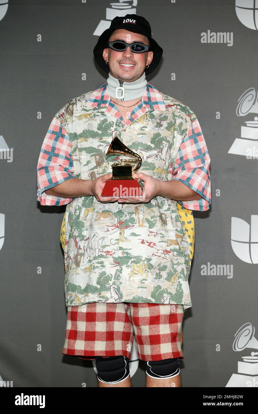 Bad Bunny poses in the press room with the award for best urban music ...
