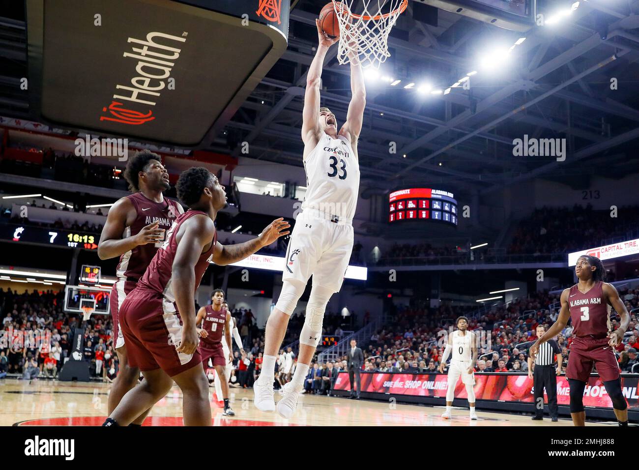 Cincinnati's Chris Vogt (33) dunks as Alabama A&M's Cameron Tucker (3 ...
