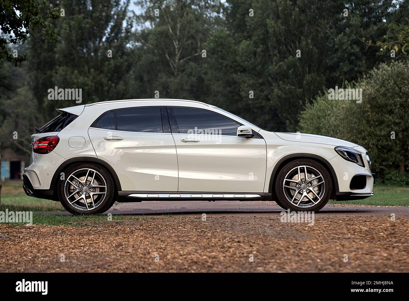 Modern white car driving in the park background, luxury city car ...