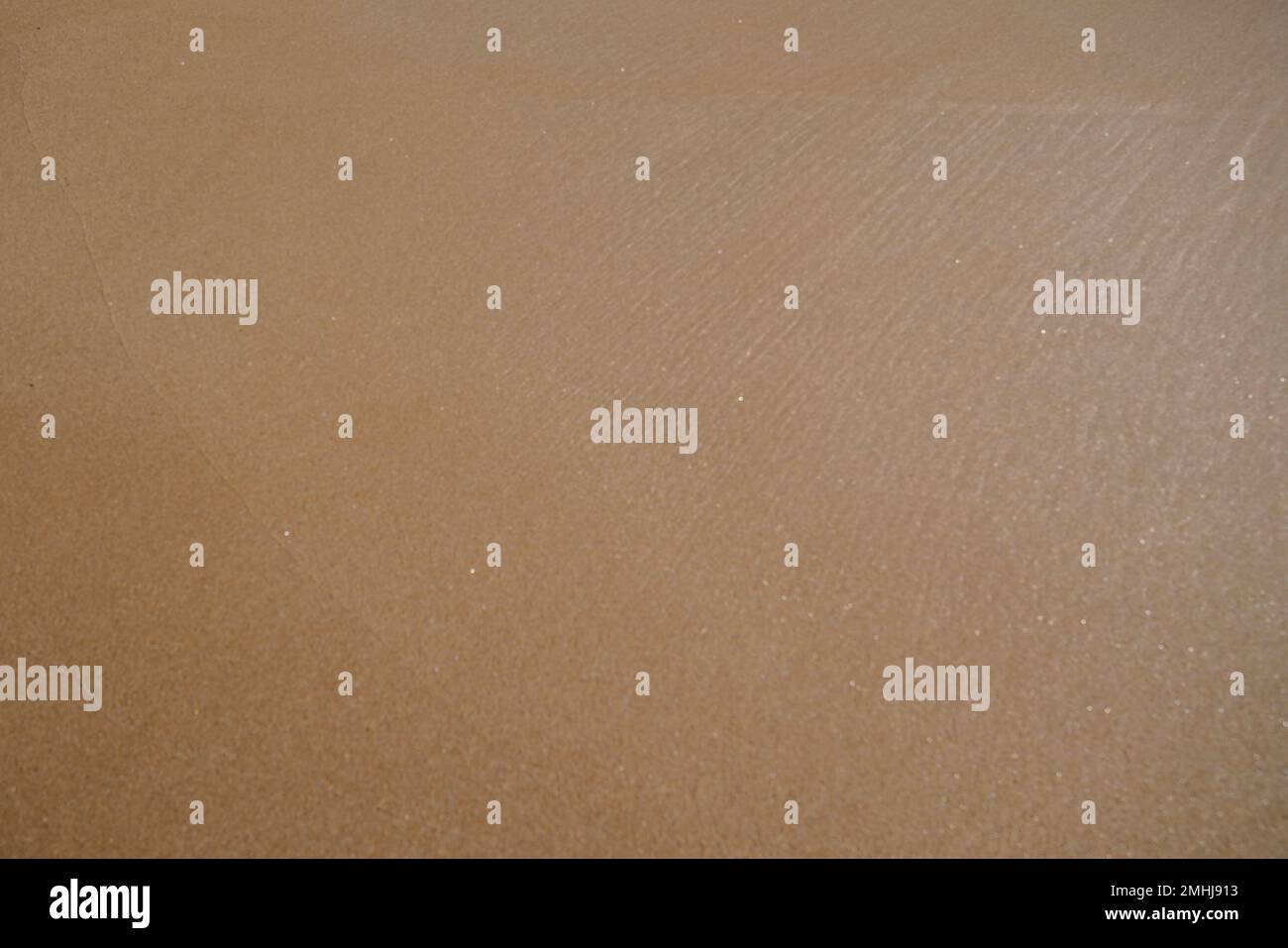 brown sandy beach wallpaper of natural sand background Stock Photo - Alamy