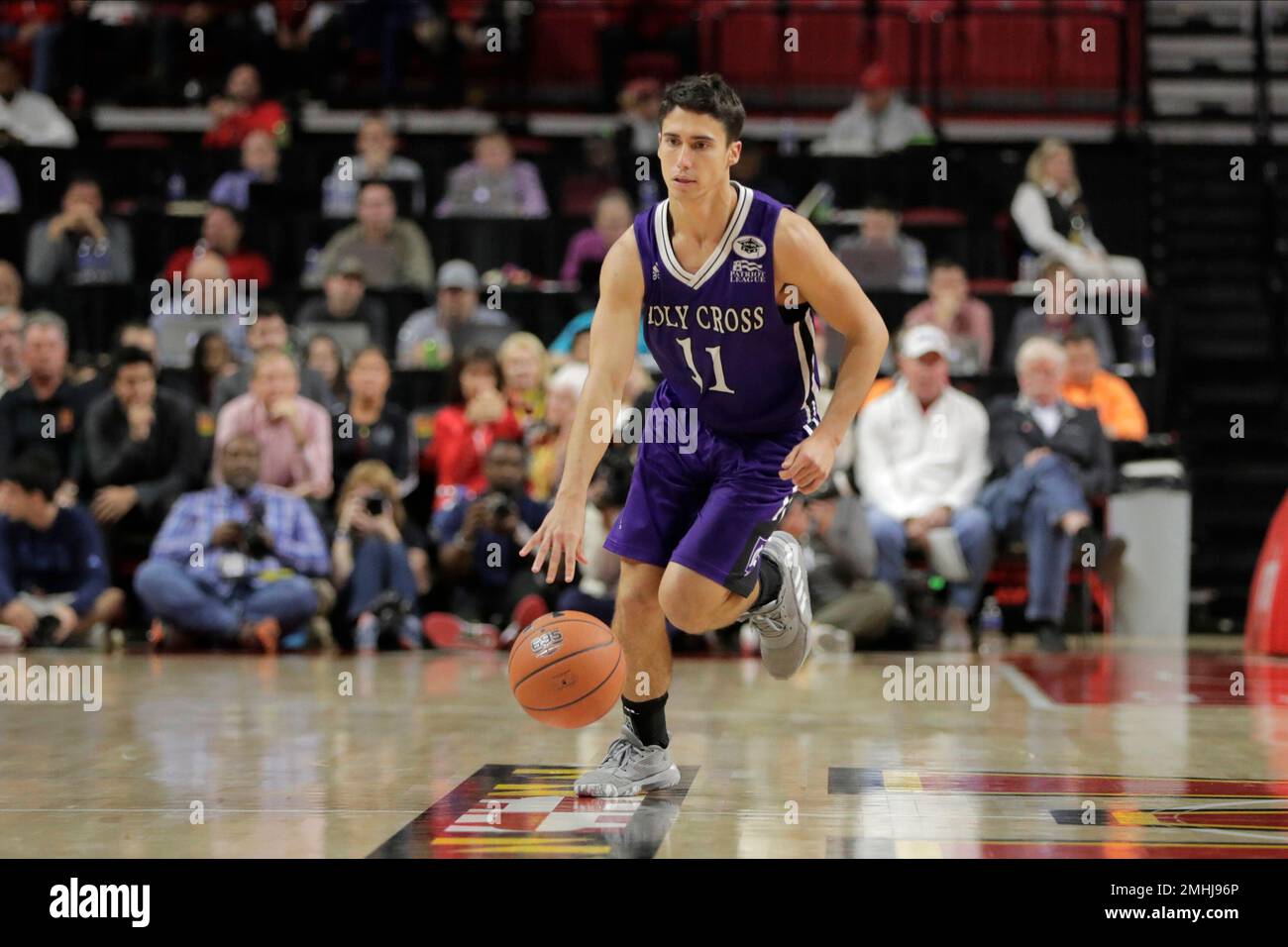 Holy Cross guard Joey Reilly dribbles up court against the Maryland ...