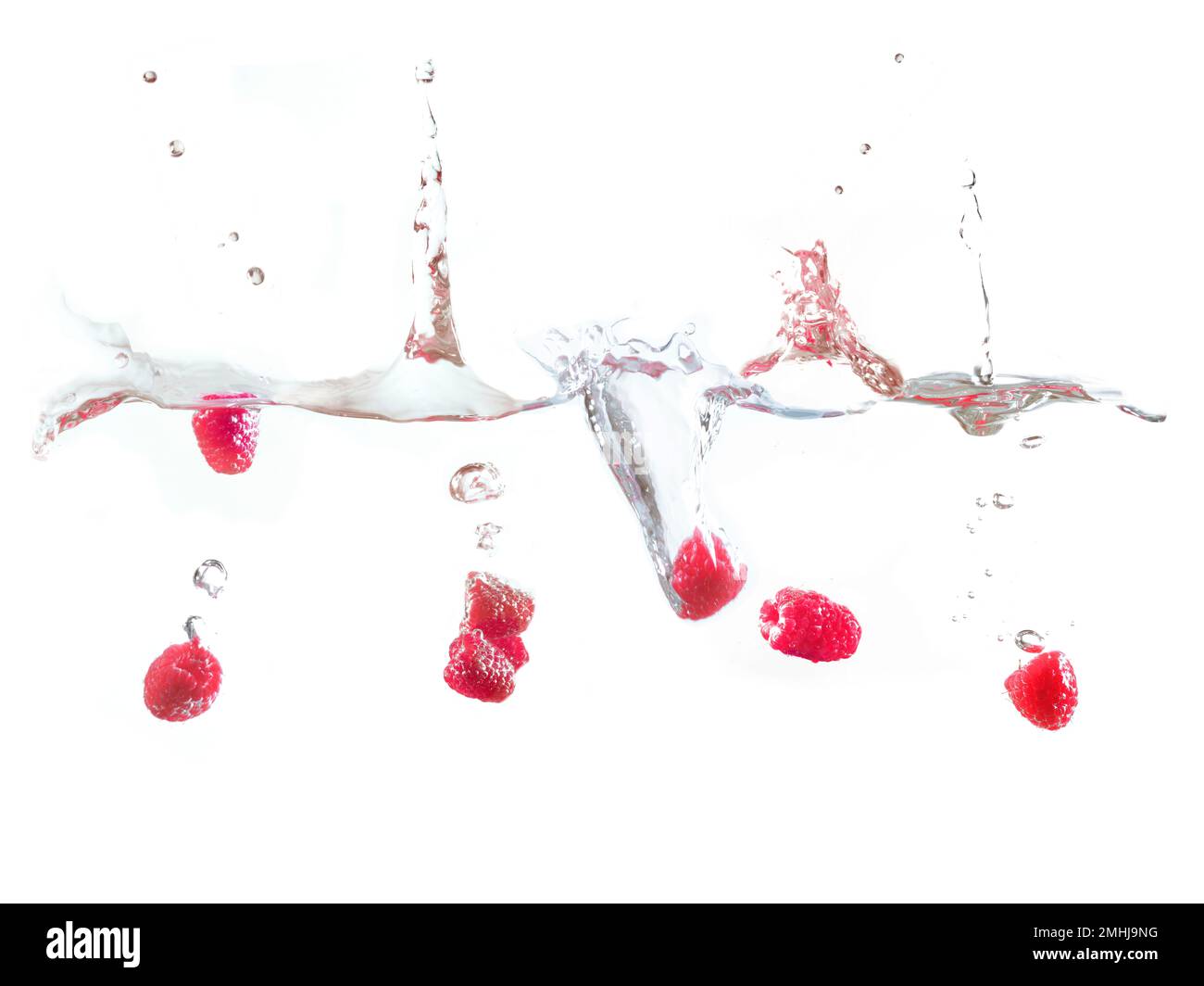 Raspberry falls deeply under water with a big splash Stock Photo - Alamy