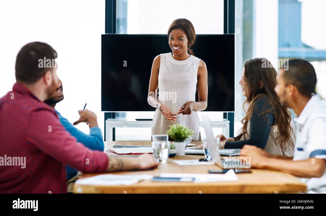 Fielding some questions. a young female designer giving a presentation ...
