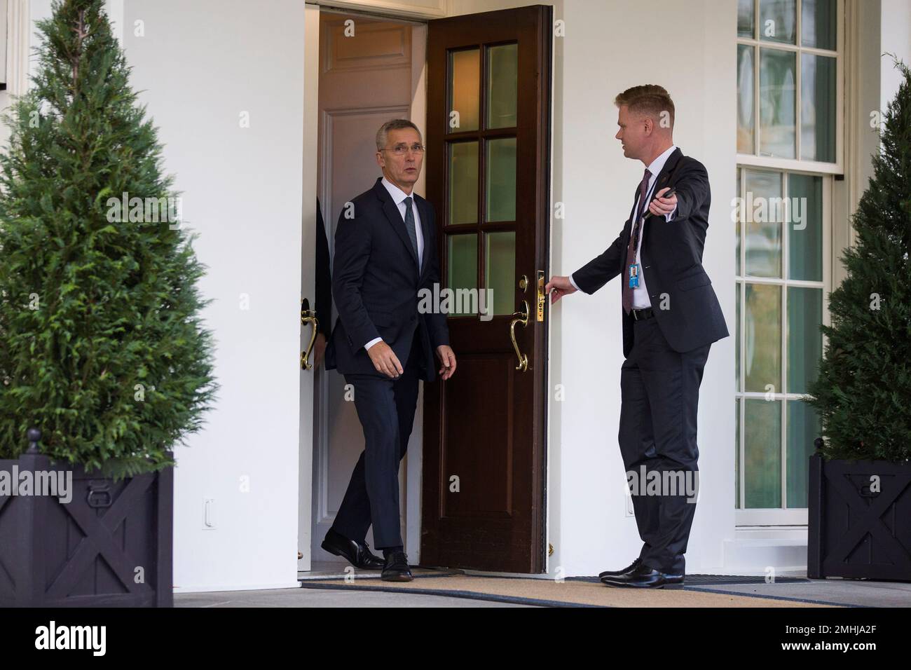 NATO Secretary-General Jens Stoltenberg walks from the West wing to ...