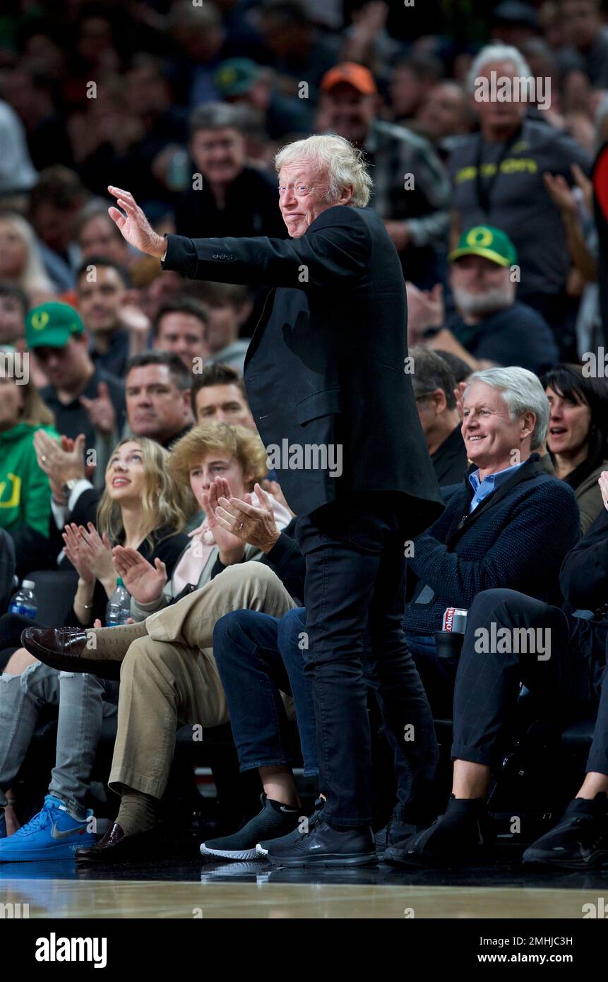 Nike co-founder Phil Knight waves to the crowd during the second half ...