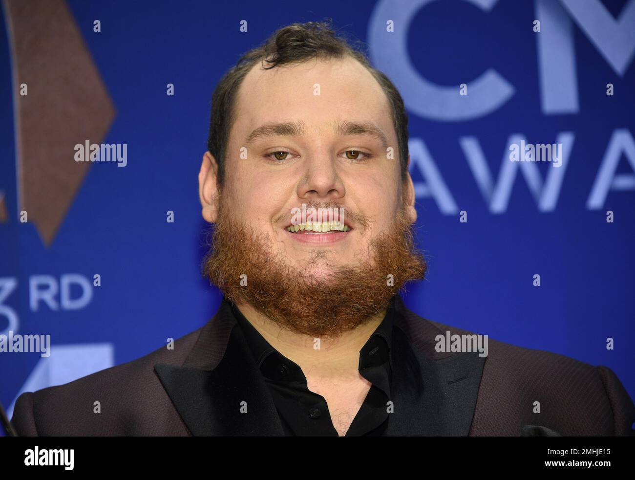 Singer-songwriter Luke Combs poses in the press room with awards for ...