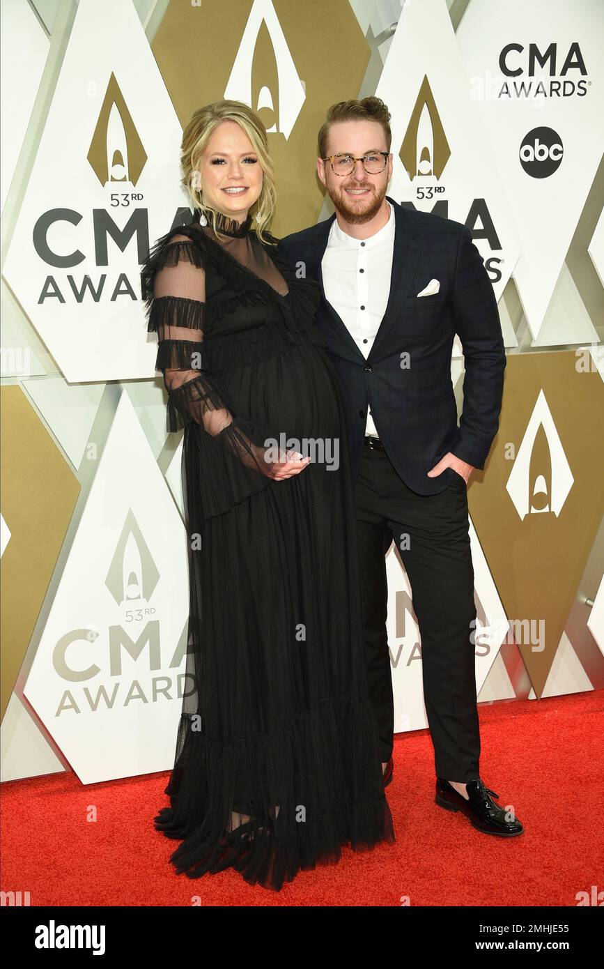 Jordan Reynolds, right, arrives at the 53rd annual CMA Awards at ...
