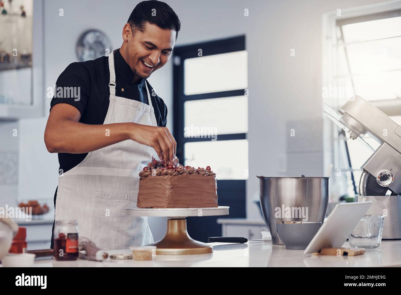 Chef, baking and cake with chocolate in a kitchen by a happy man ...