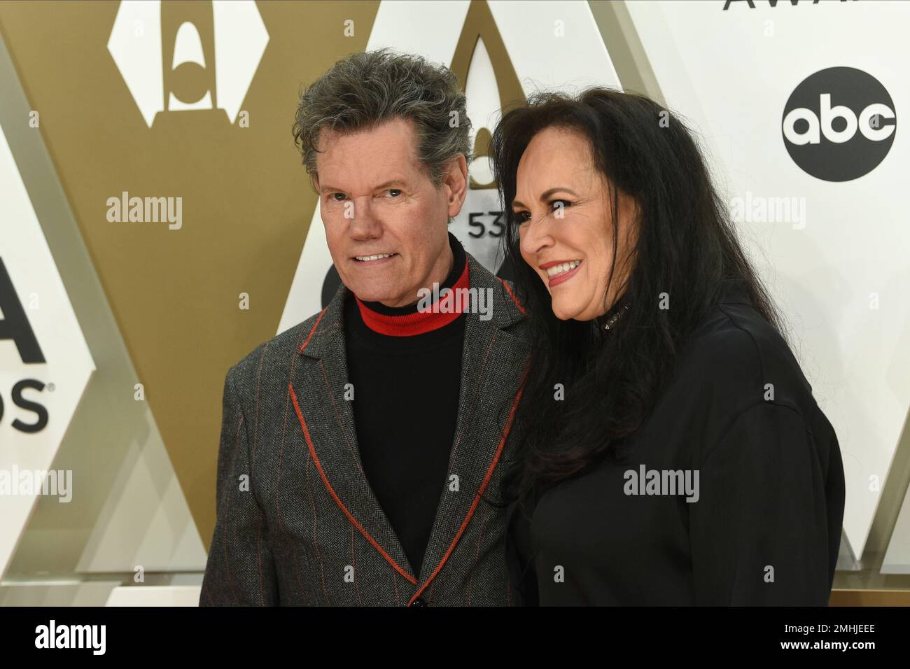 Randy Travis, left, and Mary Davis arrive at the 53rd annual CMA Awards ...