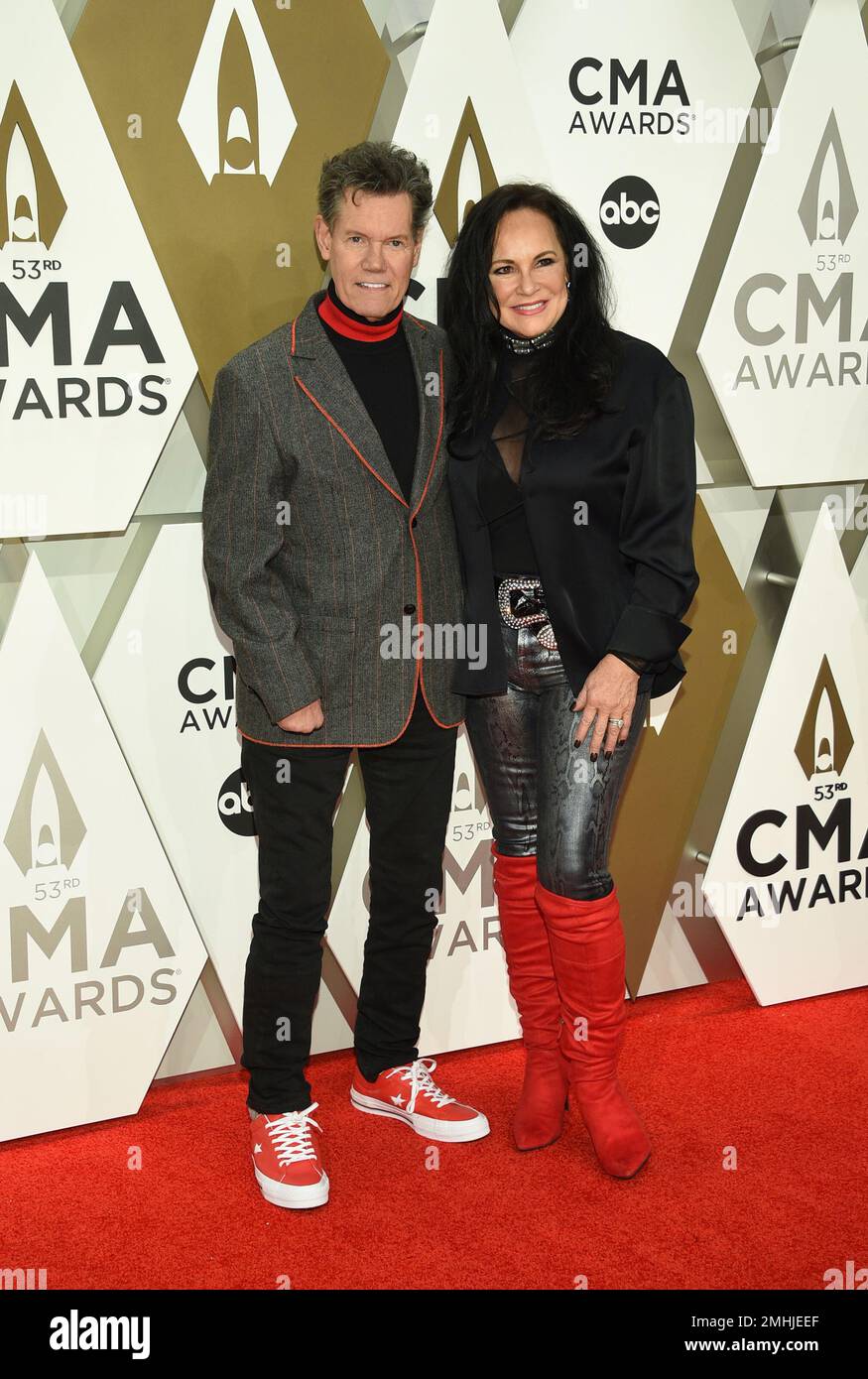 Randy Travis, left, and Mary Davis arrive at the 53rd annual CMA Awards ...