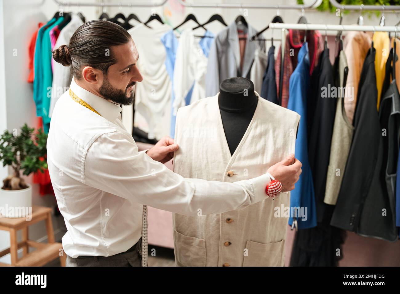 Tailor working on new piece of clothing Stock Photo - Alamy