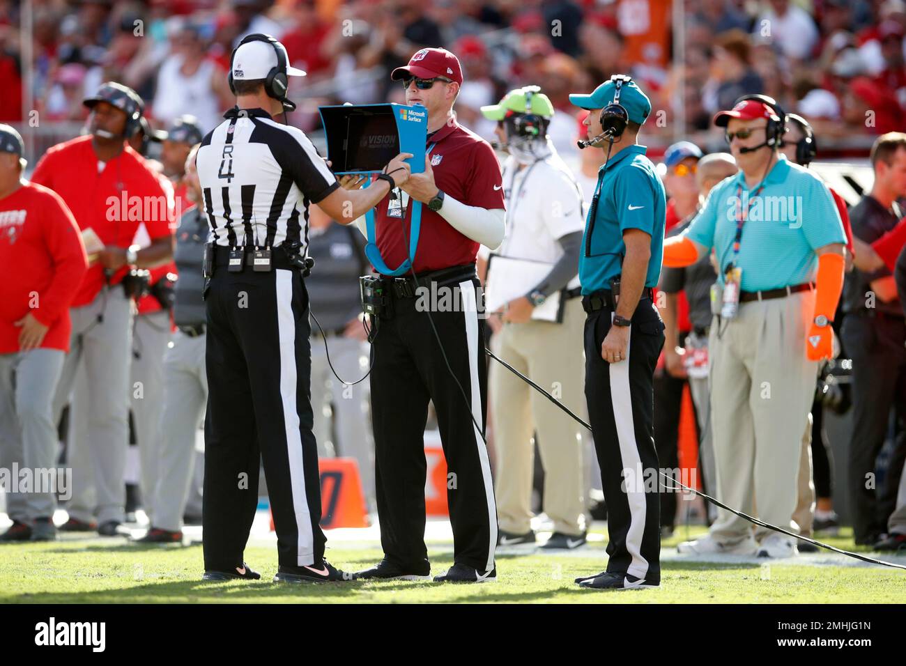 NFL referee Craig Wrolstad (4) goes in for an instant replay review ...