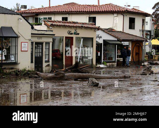 FILE - In this Jan. 9, 2018 file photo Debris and mud cover the street ...