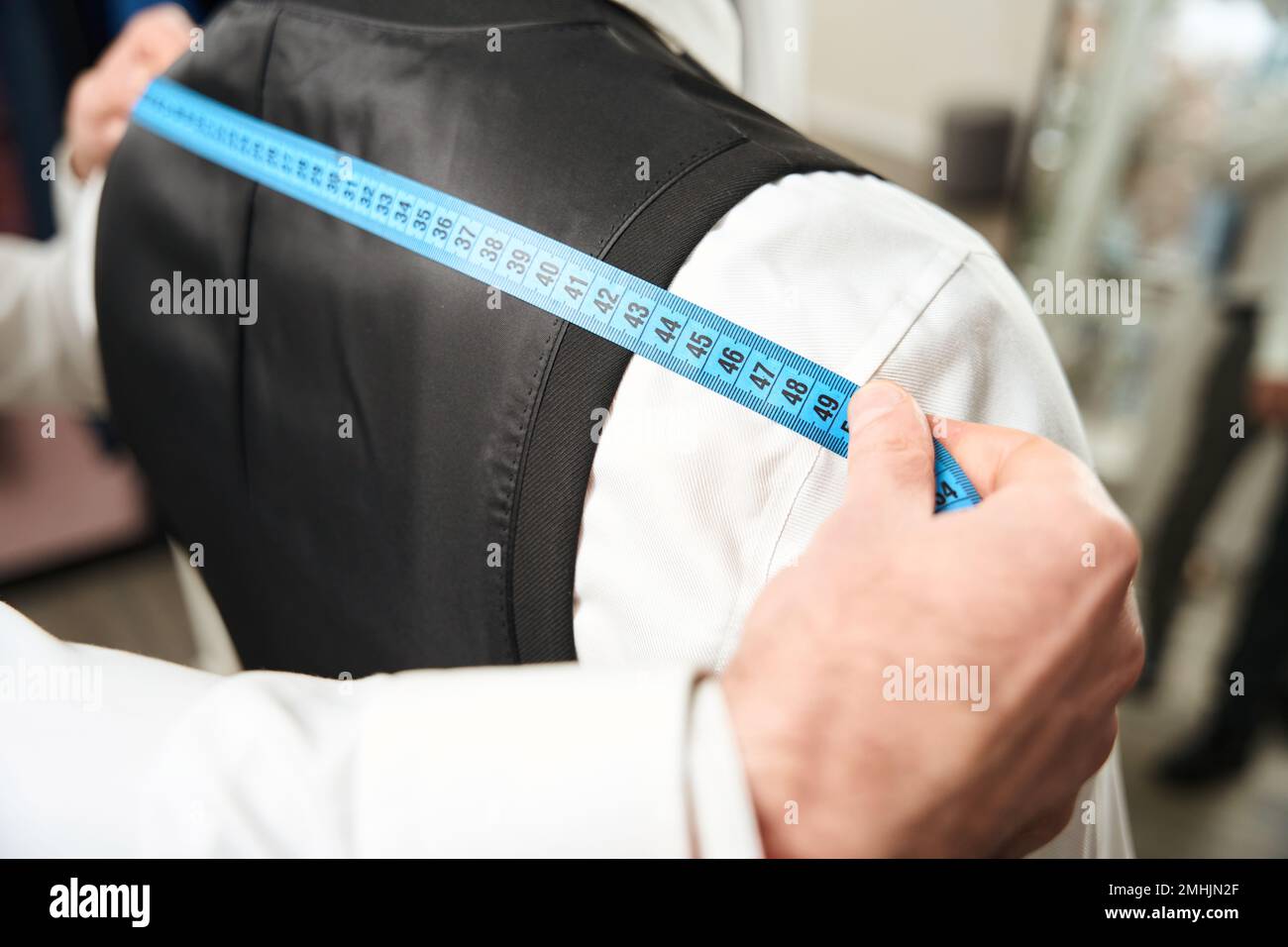 Professional tailor taking body measurements of adult person Stock ...
