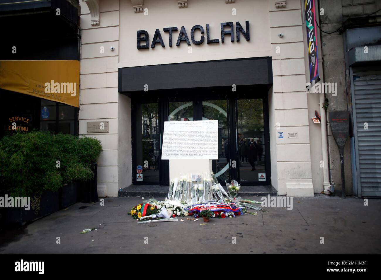 A commemorative plaque and flowers are pictured at the entrance of the ...