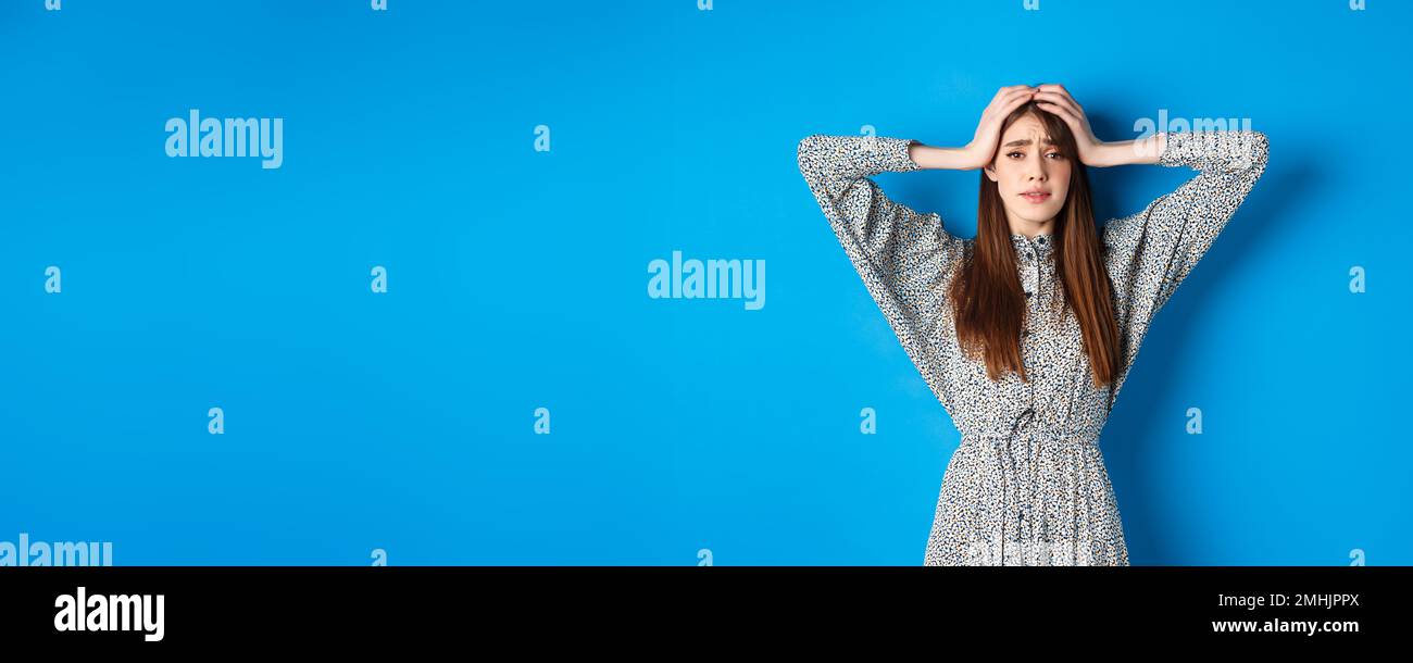 Frustrated adult woman with natural hair holding hands on head and ...