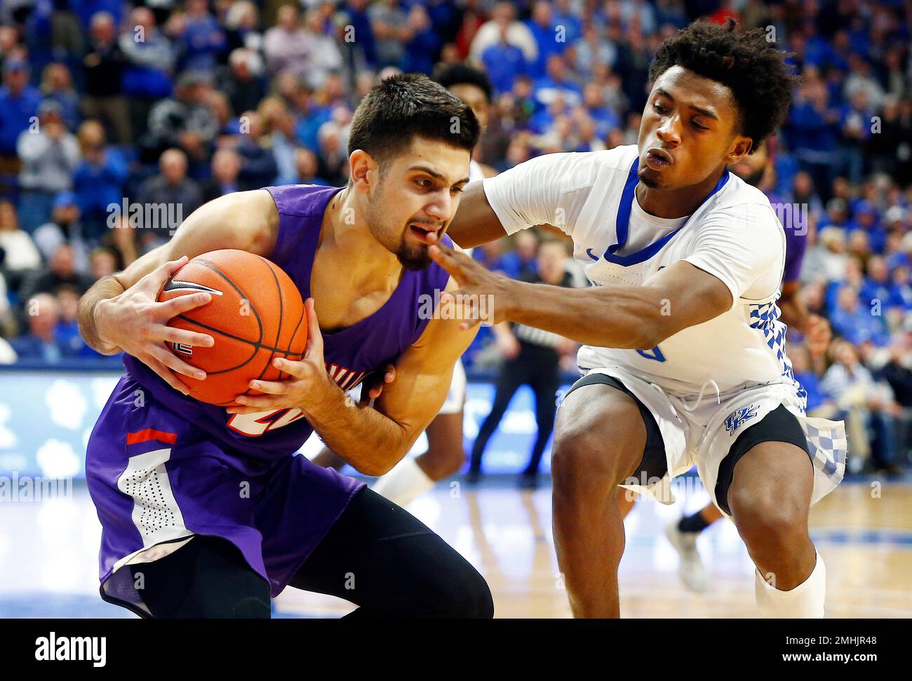 Evansville's Sam Cunliffe, left, is fouled by Kentucky's Ashton Hagans ...