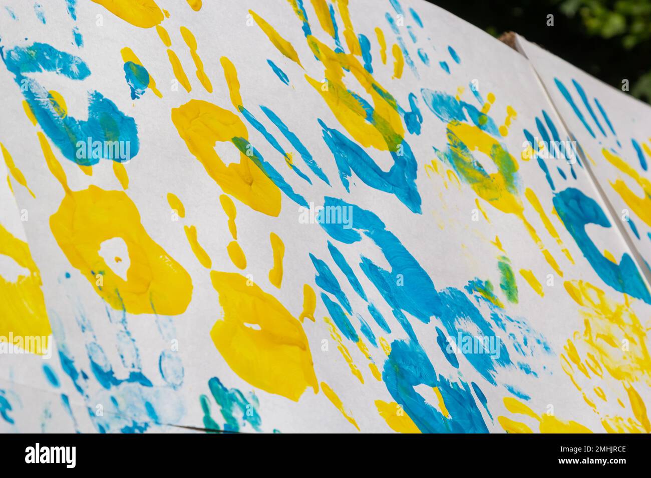 bright prints of children's hands from paint on the wall, background ...