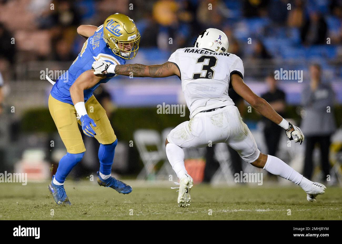 UCLA wide receiver Kyle Philips, left, avoids a tackle by Colorado ...