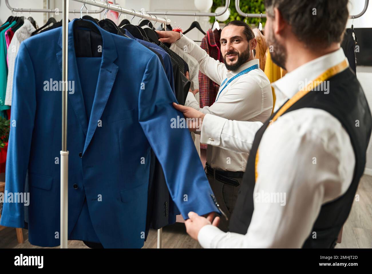 Tailor with colleague working in sewing workshop hi-res stock ...
