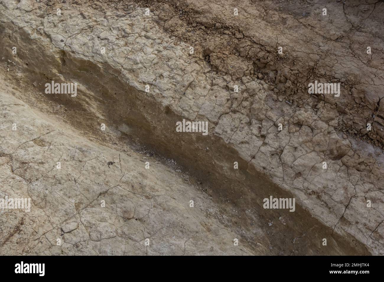 Dirty washed dirt road with traces of water flow in spring. Off-road ...