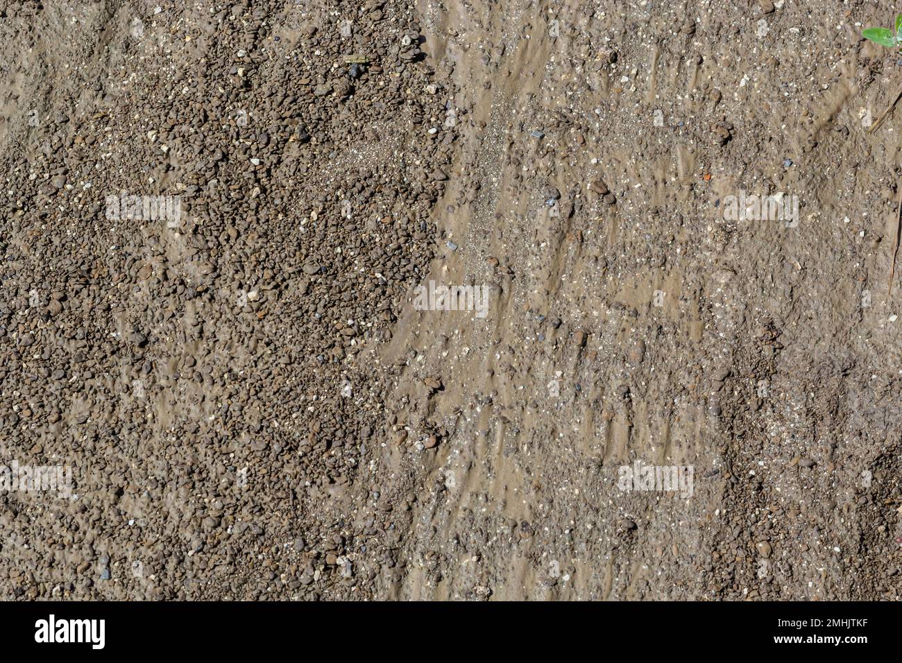 Dirty washed dirt road with traces of water flow in spring. Off-road ...