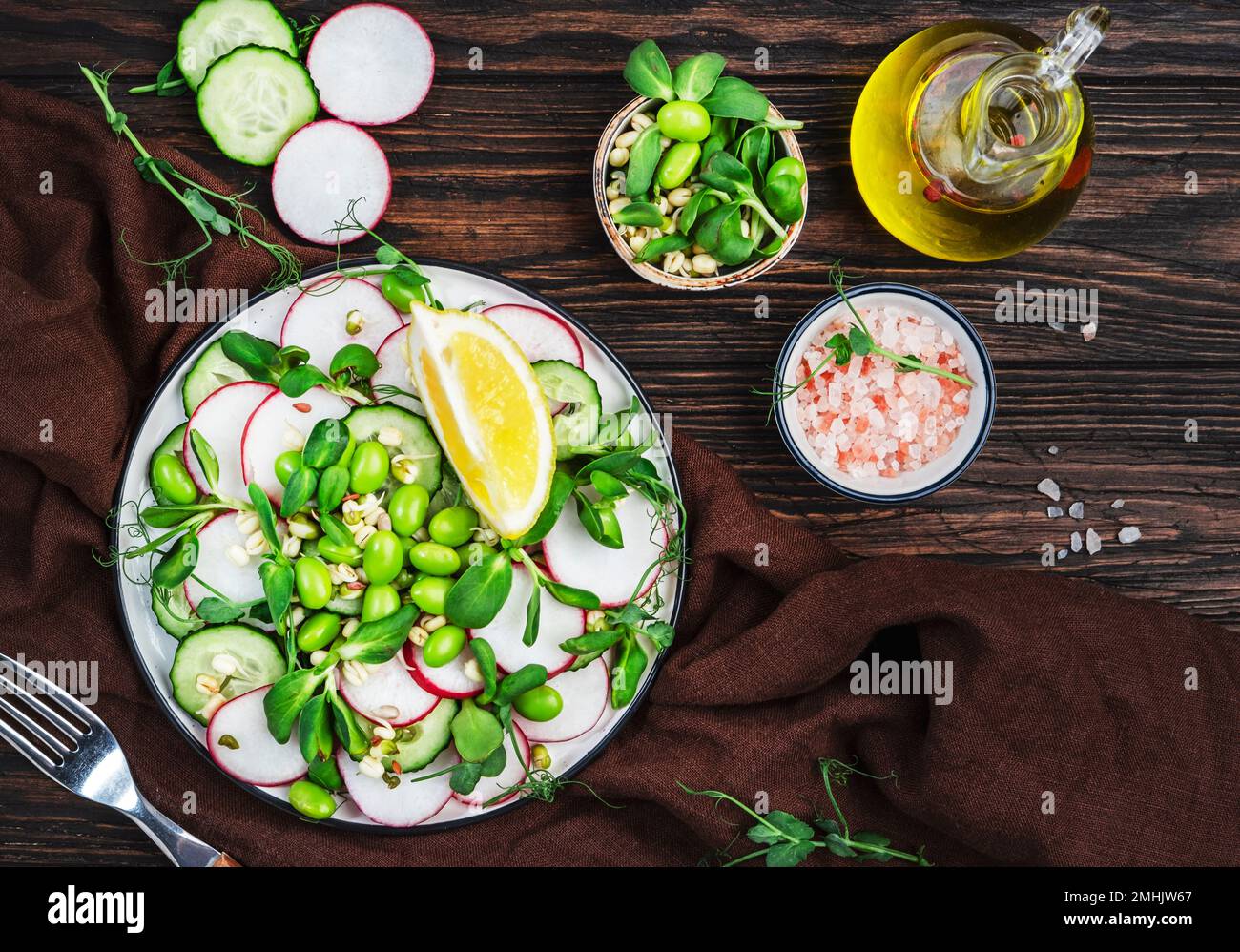 Fresh salad with radish, cucumber, green pea, sunflower and soy sprouts ...