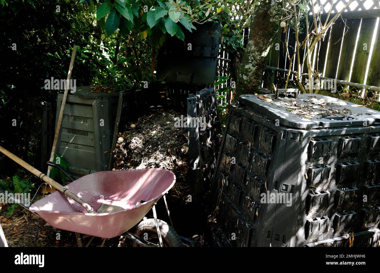 A compost bin is open, the compost is going to be shoveled into the ...