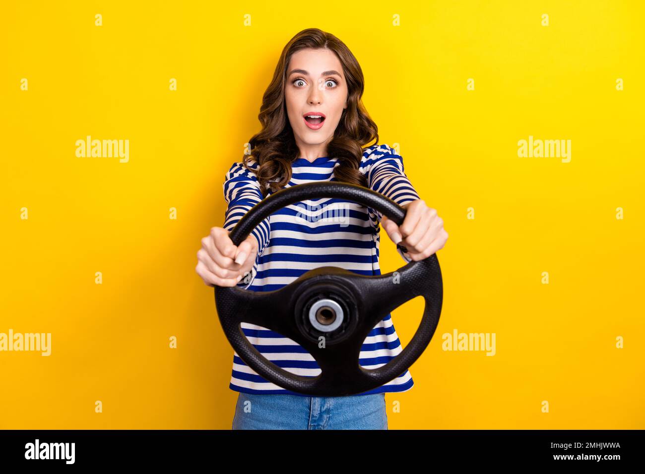 Photo portrait of attractive young woman hold steering wheel look ...