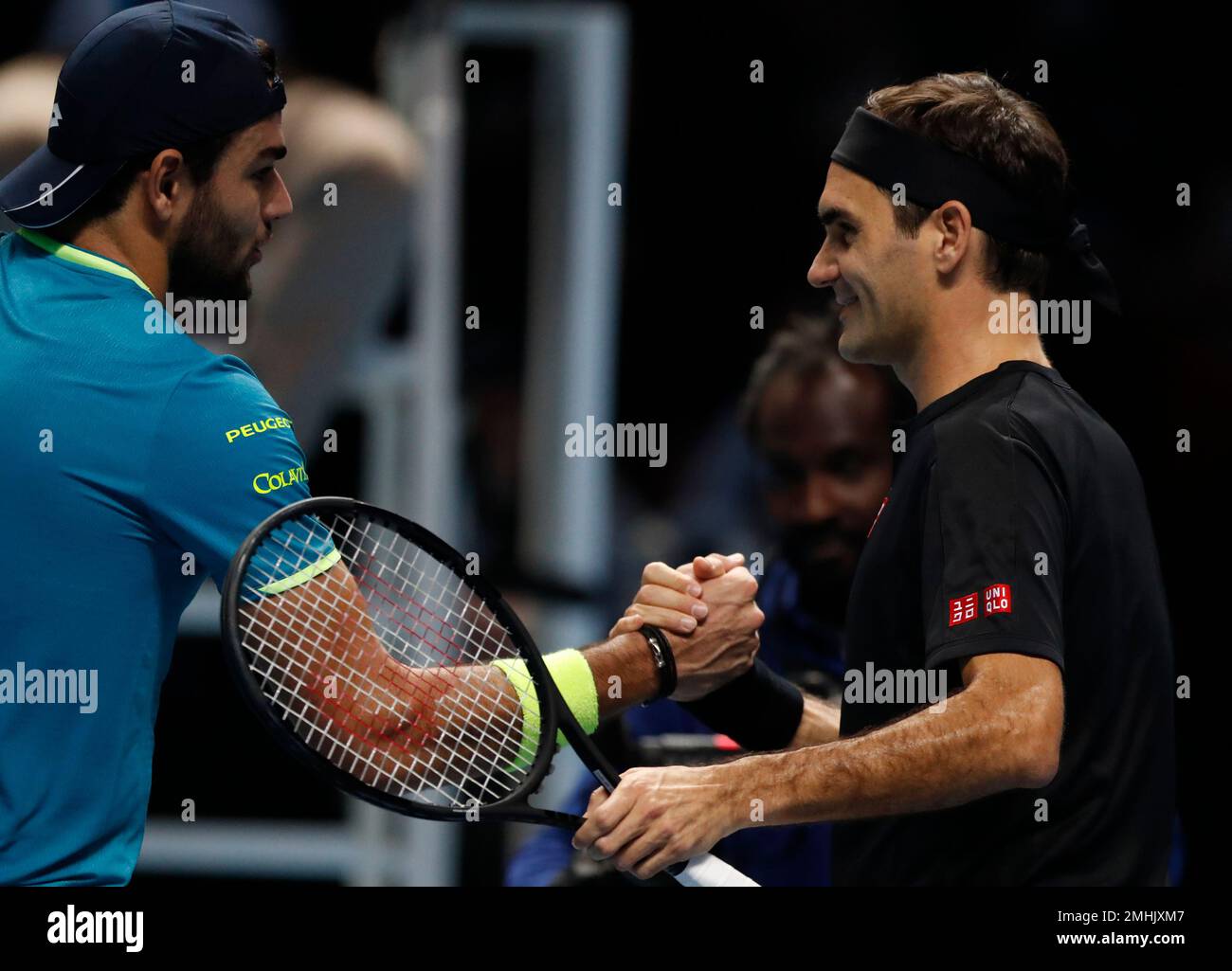 Switzerland's Roger Federer, right, shakes hands with Italy's Matteo ...