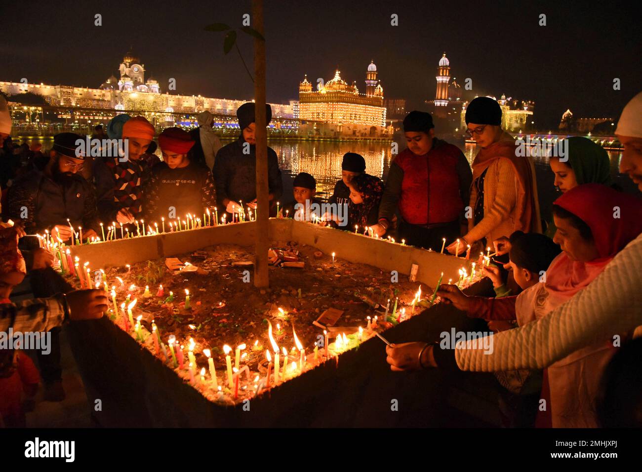 Sikhs light candles at the Golden Temple, the holiest of Sikh shrines on the birth anniversary ...