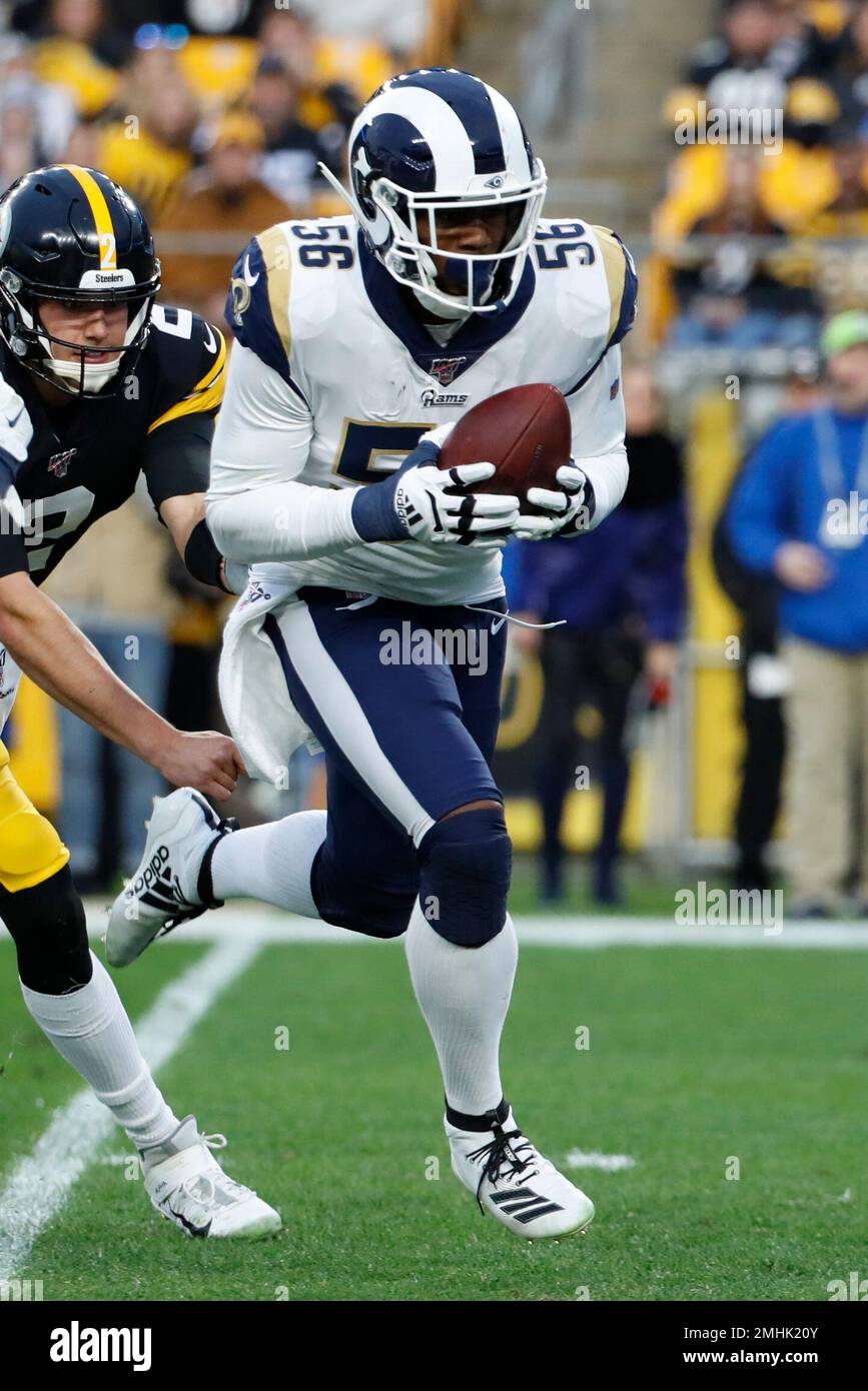 Los Angeles Rams defensive end Dante Fowler (56) recovers a fumble and ...