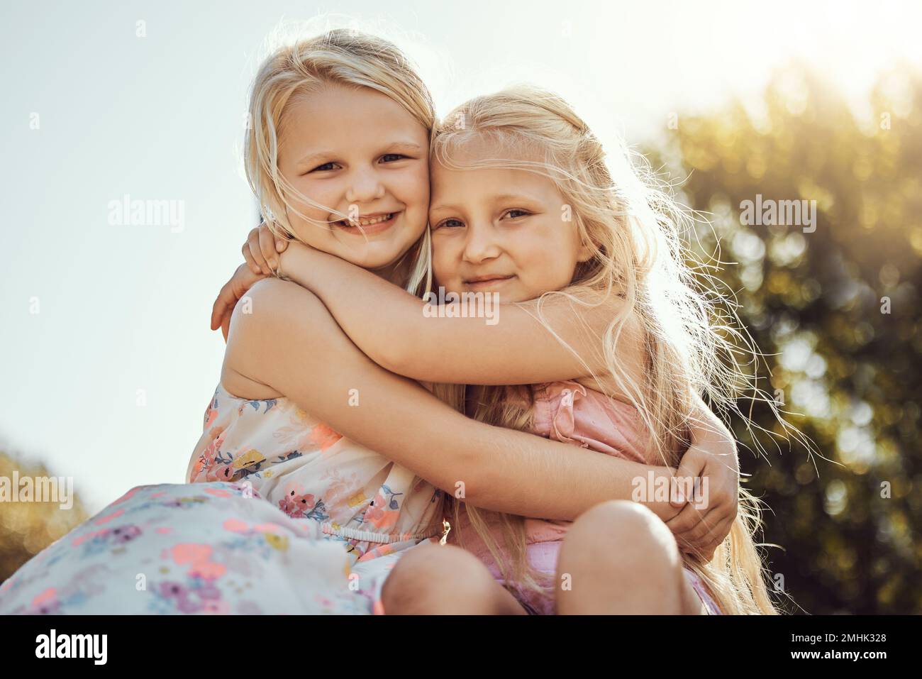 Hug, nature and portrait of girl siblings bonding, hugging and playing ...