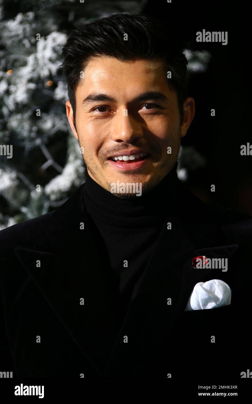 Actor Henry Golding poses for photographers upon arrival at the ...