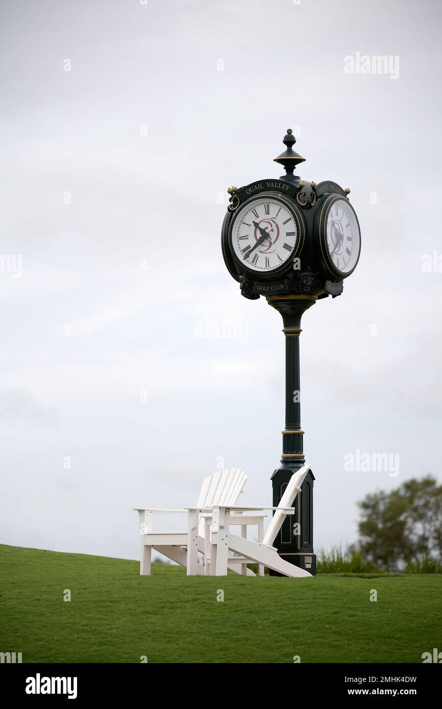 A clock is viewed at the 18th green during an NCAA golf tournament on ...