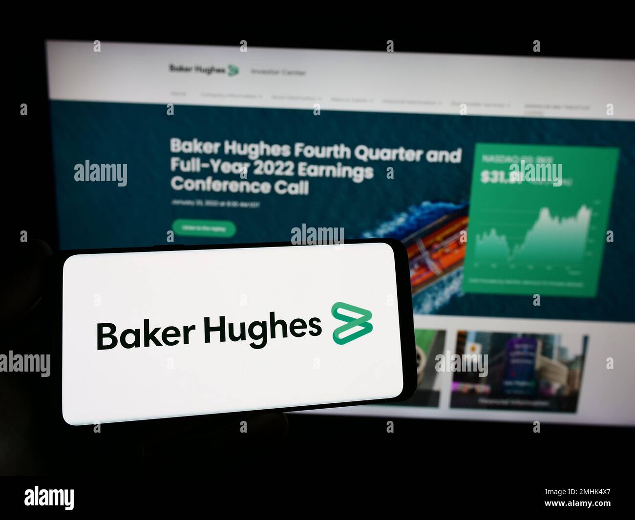 Person holding smartphone with logo of oil field services provider ...