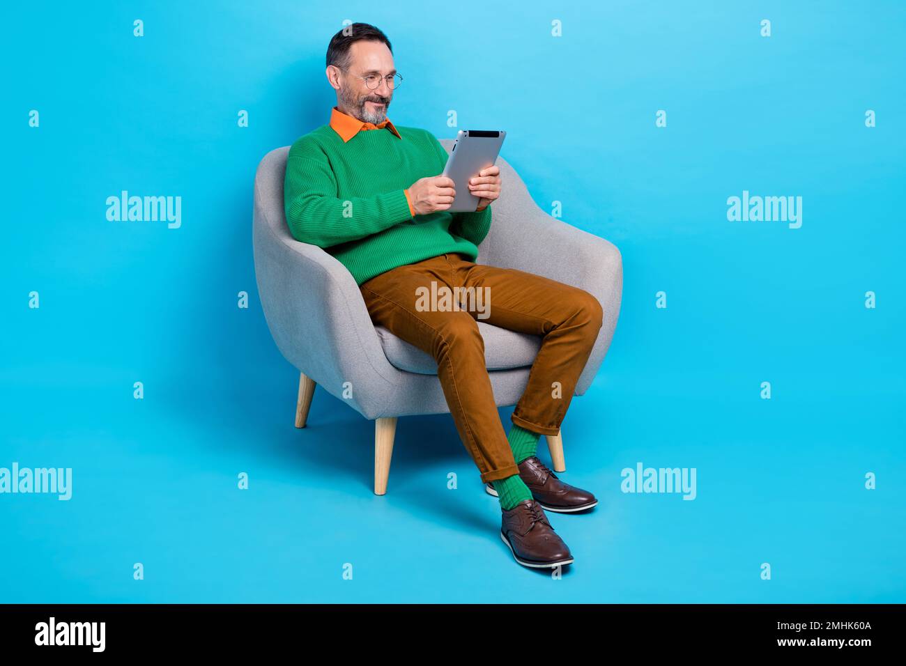 Full body photo of mature handsome man read news hold tablet gadget ...