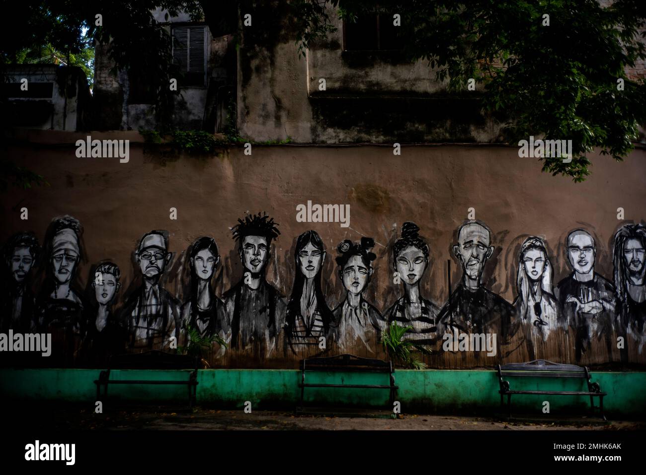 In this Nov. 10, 2019 photo, a wall is covered by a mural of faces ...