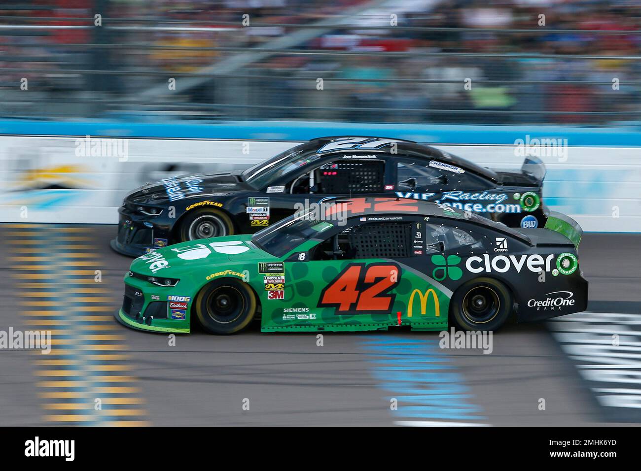 Kyle Larson (42) and Joe Nemechek (27) race side-by-side during the ...