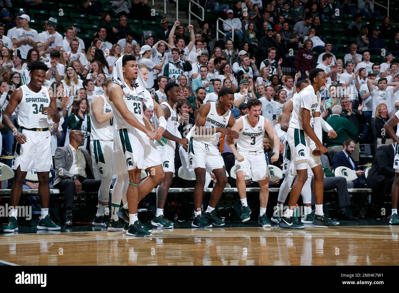The Michigan State bench reacts during the second half of an NCAA ...