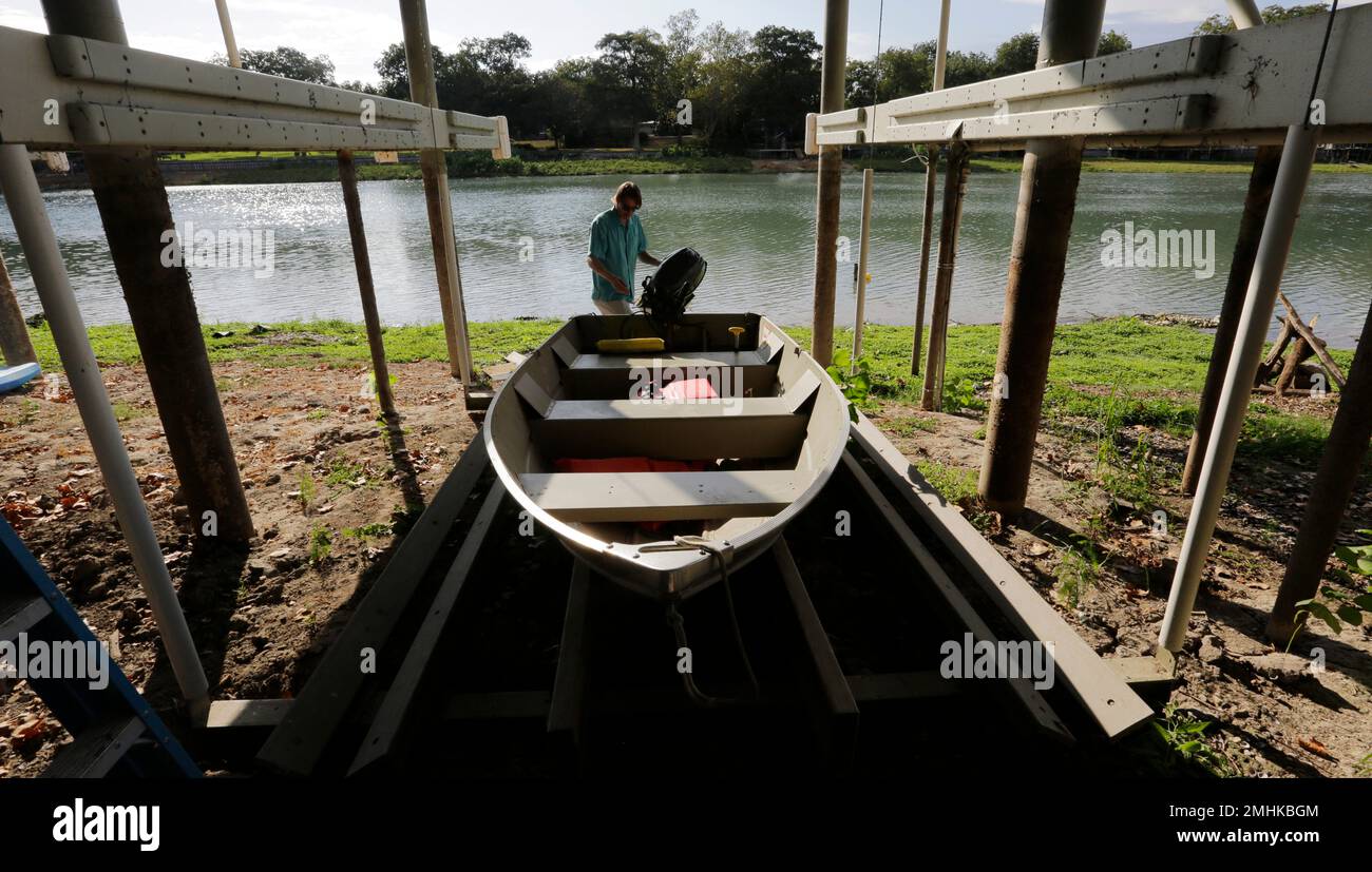 Hunter Croan uses a make-shift ramp to move his jon boat to the water ...