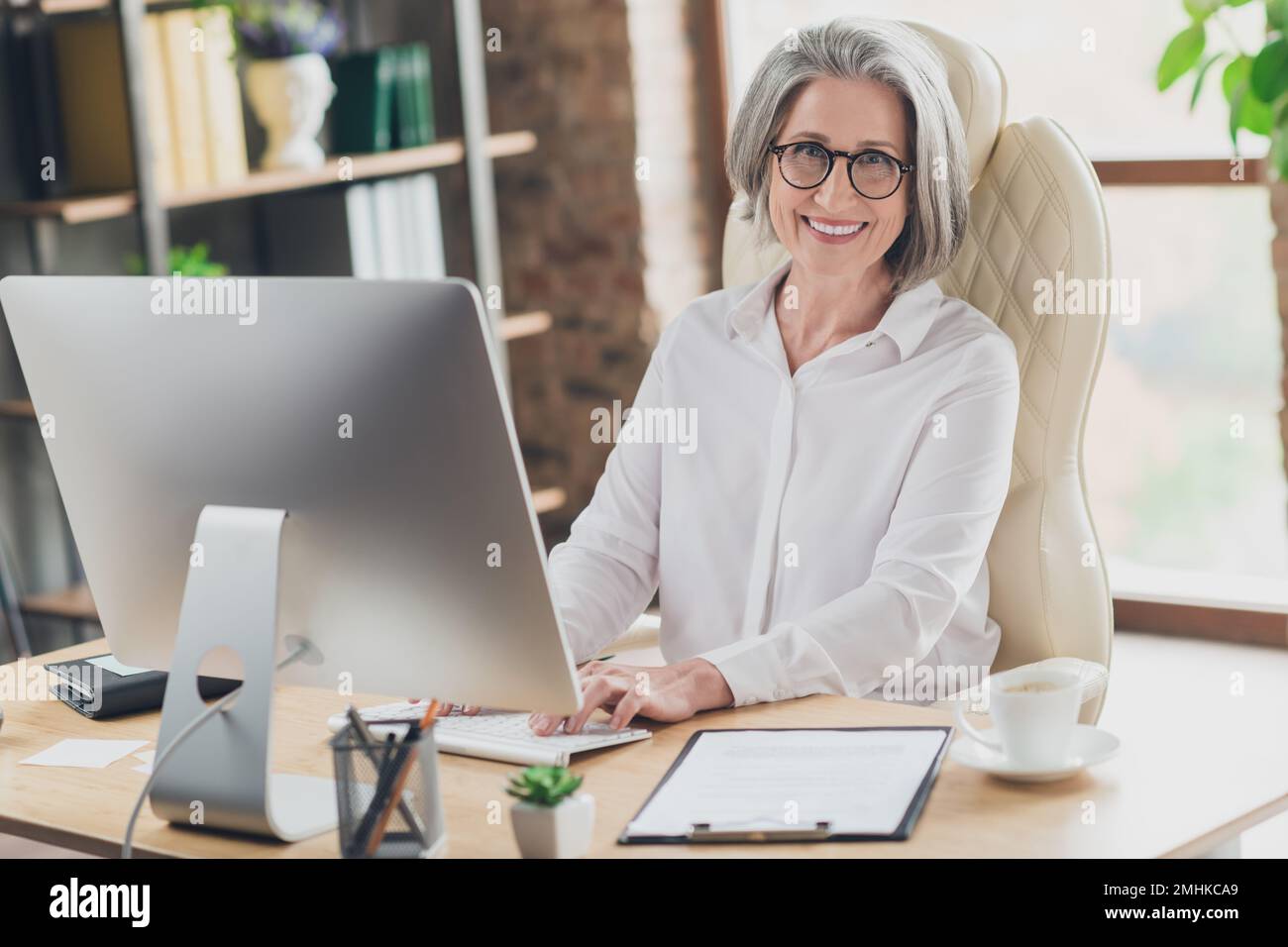 Photo of intelligent banker lady sitting leather chair keyboard write ...