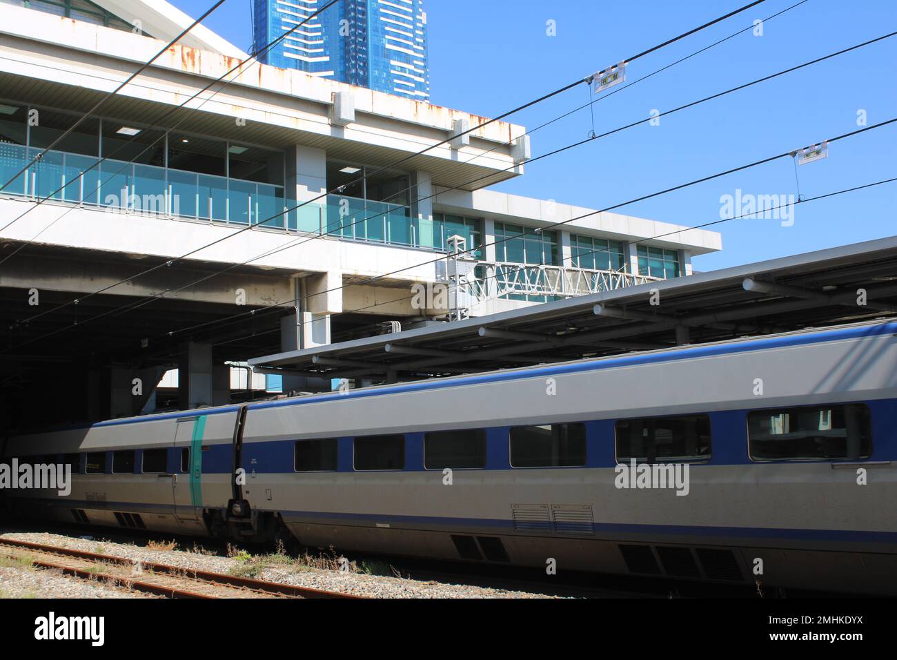 Passenger train coming into station Stock Photo - Alamy