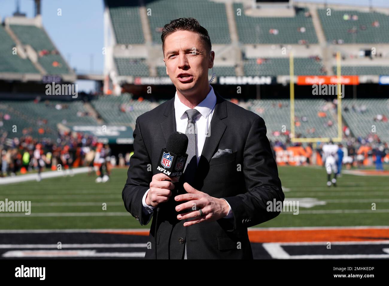 NFL reporter Tom Pelissero works the field during practice before an ...