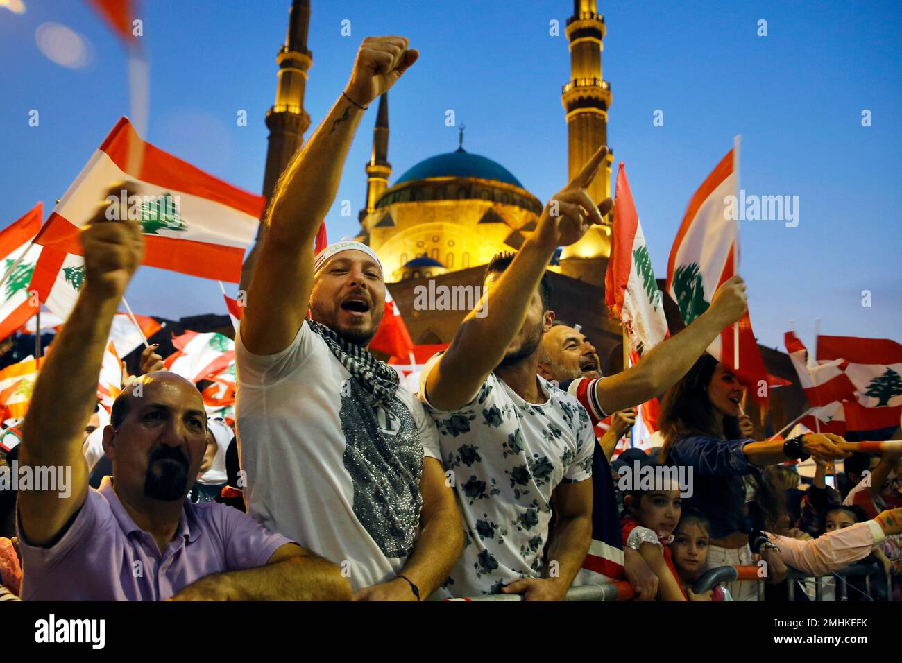 Anti-government protesters wave Lebanese flags and chant slogans ...