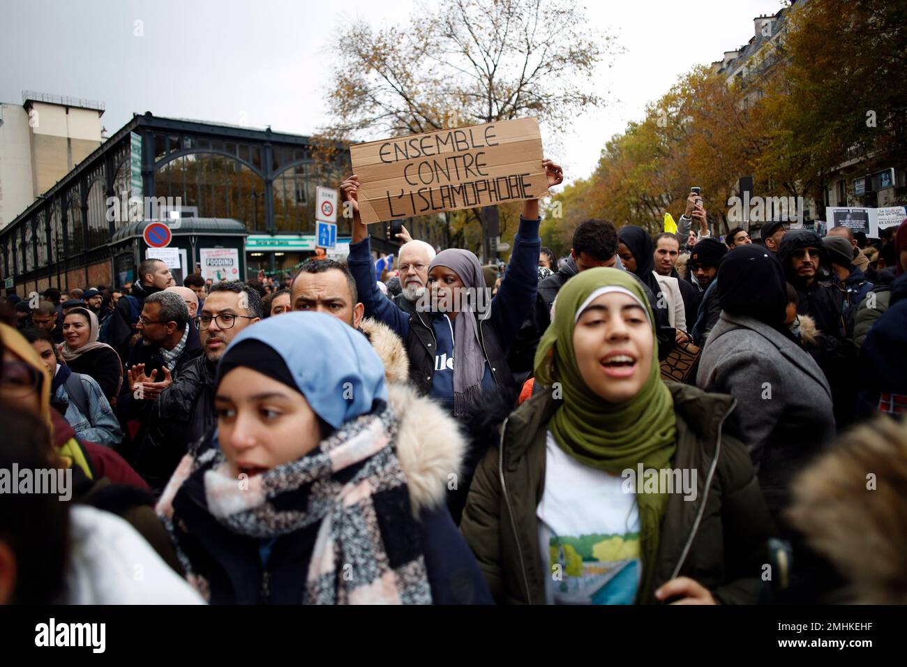 A protestor holds a placard reading "Together against islamophobia ...