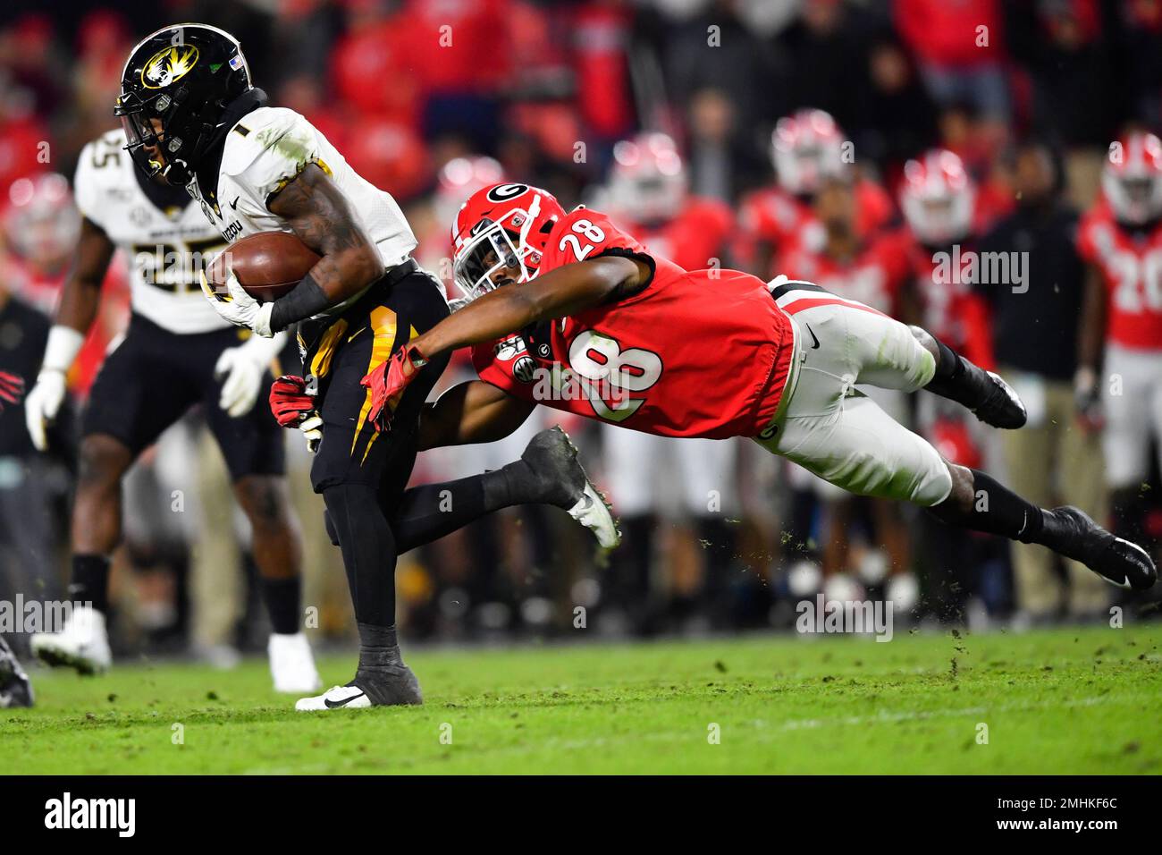 Georgia's Anthony Summey (28) tackles Missouri running back Tyler Badie ...
