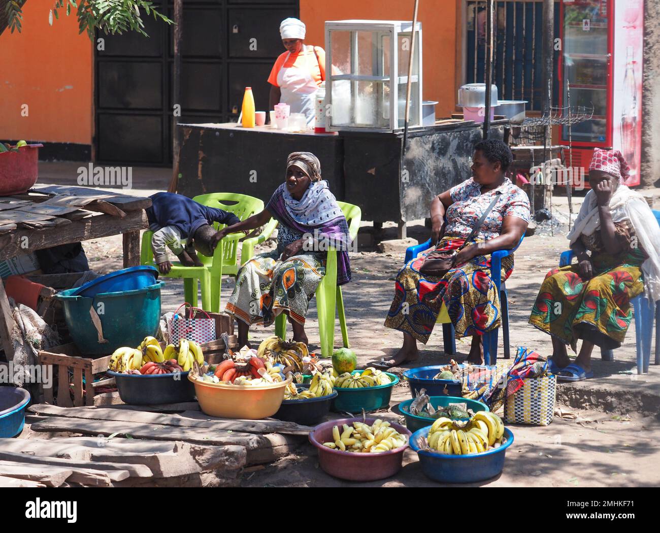 Arusha, Tanzania. 21st Sep, 2022. Three women sit behind bowls of ...