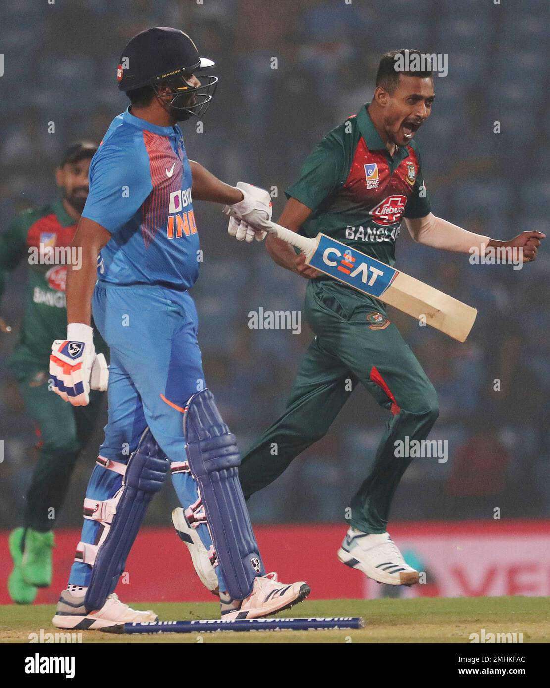Bangladesh's Shafiul Islam, right, celebrates the dismissal of India's ...
