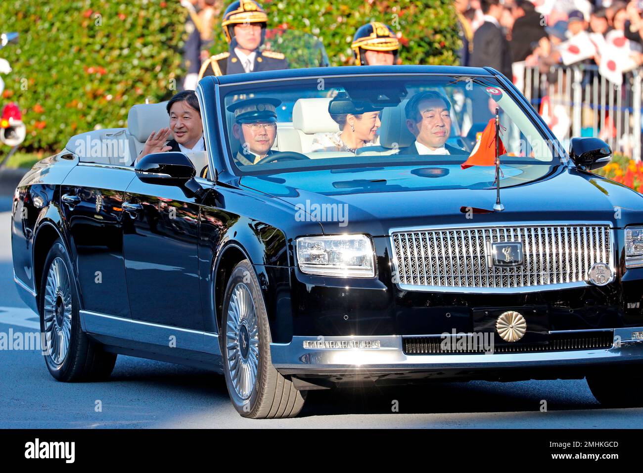 Japanese Emperor Naruhito, left, and Empress Masako, right, wave to ...